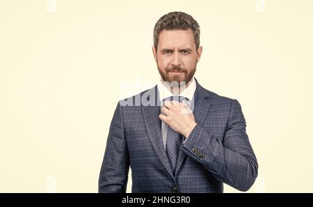 Middle-aged manager fix necktie wearing elegant blue suit in formal ...