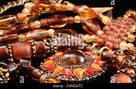 Necklaces and Bracelets on Black Background, Close-up Stock Photo - Alamy
