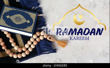 Greeting card for Ramadan with Koran and prayer beads on light ...