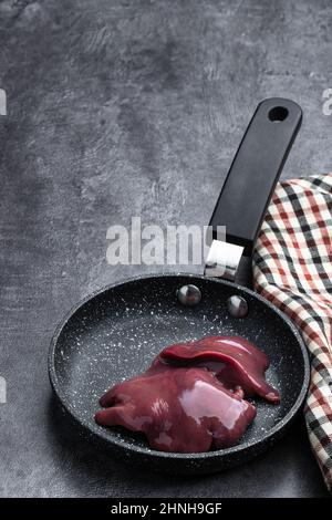 Raw offal, beef liver, prepared for cooking on rustic wood board. Fresh ...