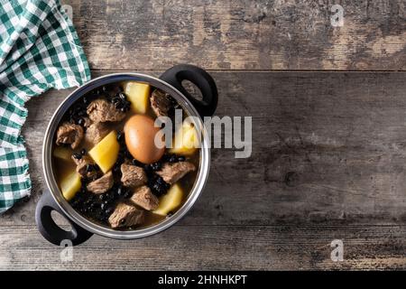 Traditional Jewish cholent on wooden table Stock Photo - Alamy