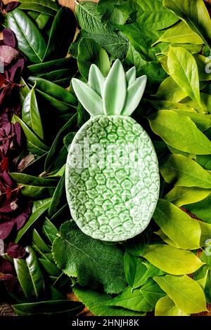 Creative layout of green leaves, exotic wild plants on pink, top view ...