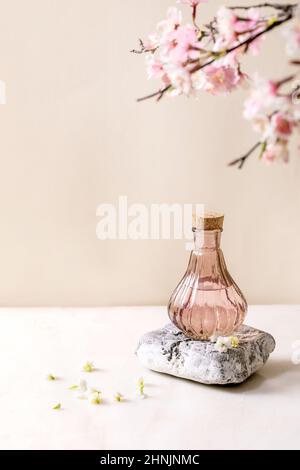 Bottle of perfume with flowers on white background Stock Photo - Alamy