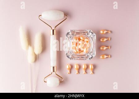 Rose Gold capsules with cosmetic oil for face in glass jar with eustoma ...
