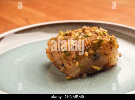 Syrian semolina cake with sugar syrup, tasty Harisse on a blue ceramic ...