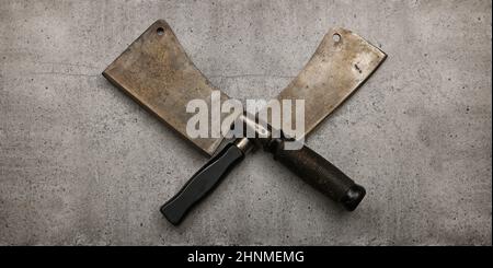 Two vintage butcher meat cleavers on table Stock Photo - Alamy