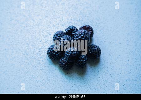BlackBerry berries stacked in a pyramid on a light background. High ...