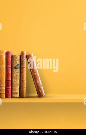 Row of old books on yellow shelf. Square scene background Stock Photo ...