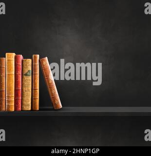 Row of old books on black shelf. Horizontal background scene Stock ...