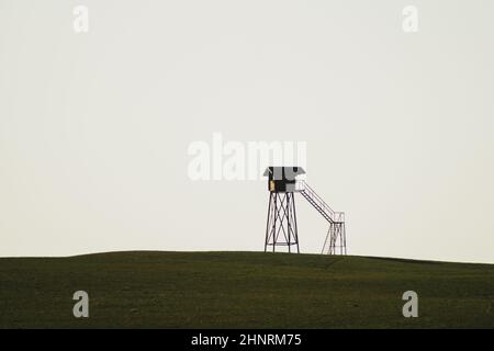 Lonely watch tower. observation post standing alone on the hill ...