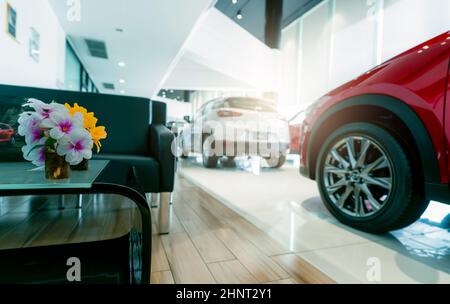 Customer reception area and blur red and white luxury SUV car parked in ...