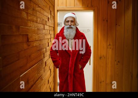 Santa Claus in red bathrobe in sauna Stock Photo - Alamy