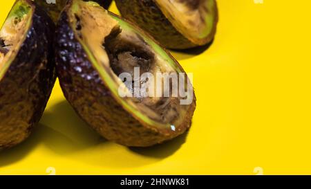 Bad avocado fruits Close up. Ugly fruits on Yellow background. Overripe ...