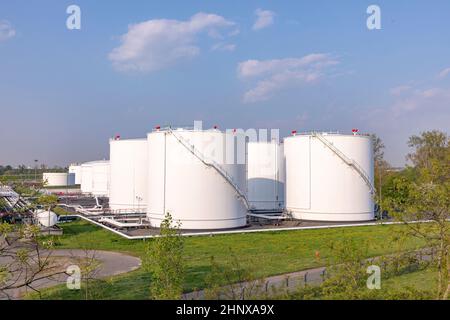 white oil tanks under blue sky Stock Photo - Alamy