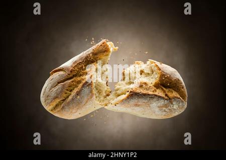 Fresh crunchy baked bread opened on brown background Stock Photo - Alamy