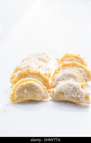 Pierogi or Vareniki, raw frozen dumplings isolated on white background ...