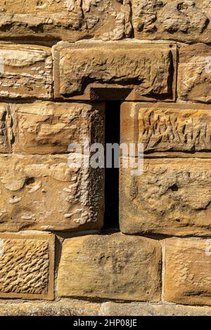 Embrasure inside of the massive high walls of an old medieval castle ...