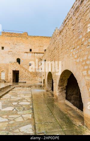The huge, majestic walls and towers of Ribat fortress on a rainy day ...