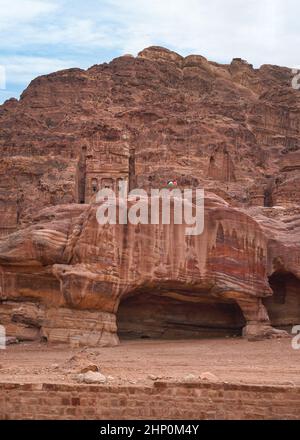 Simple dwelling ruins - cave like holes in stone wall, moon above ...