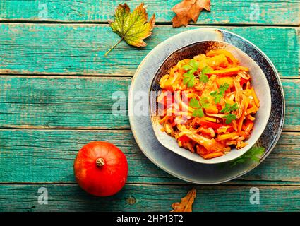 Warm autumn salad of roasted pumpkins and pork ears.Space for text ...