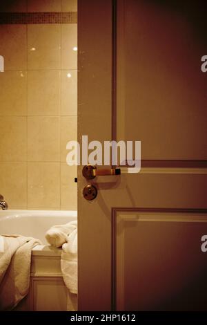 Inside a bathroom with a view of towels and bathtub shower combo kit ...