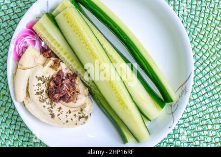 Snack of hummus and cucumber slices Stock Photo - Alamy