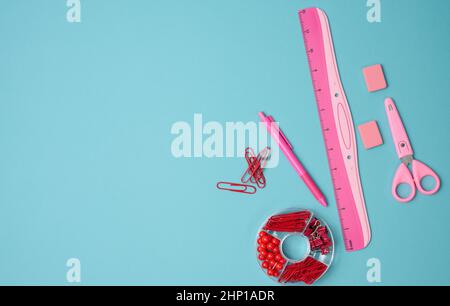 Paper clips, buttons, scissors on blue background, top view Stock Photo ...