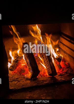 A big burning fire in the fireplace gives off a lot of heat Stock Photo ...