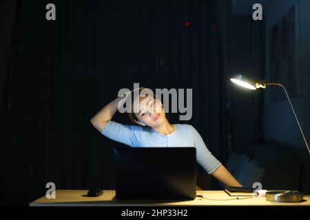 Asian woman are stretch lazily while working long hours in front of a ...