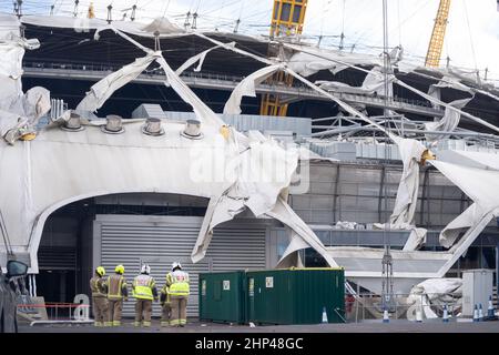 Firefighters inspect damage to the roof of the O2 Arena, in south east ...