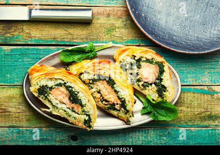 Appetizing fish pie made from salmon fish, rice and spinach. Red fish ...