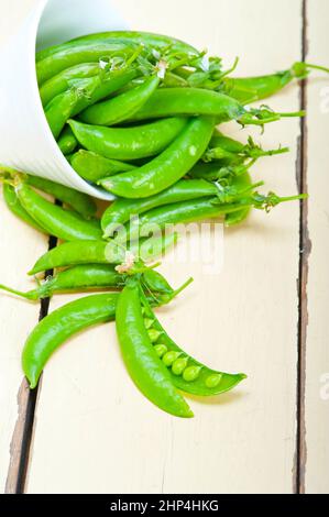hearthy fresh green peas over a rustic wood table Stock Photo - Alamy