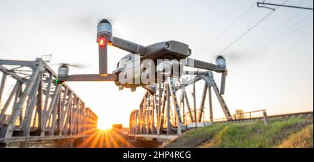 The use of drones in industry. The drone inspects the railway bridge at ...