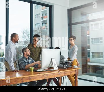 Working together to get the task done. Shot of businesspeople working ...