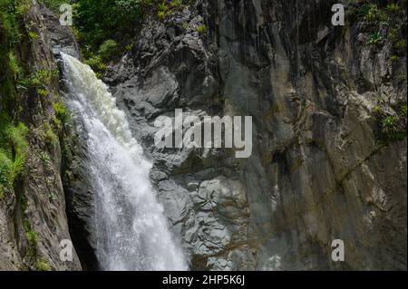 The photo shows a huge waterfall. Below is a perfectly clear water ...