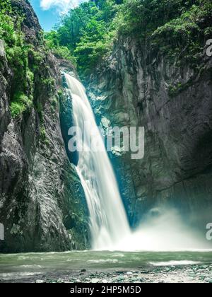 The photo shows a huge waterfall. Below is a perfectly clear water ...