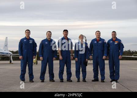 Group portrait of the STS-130 space shuttle crew astronauts in launch-and-entry suits are (L to ...