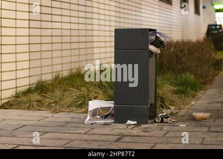 Garbage bins in the yard. An overflowing urn near the entrance of an ...