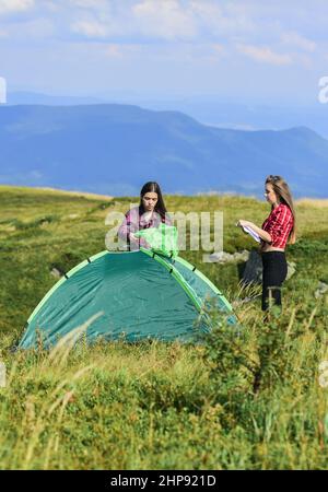 Teamwork concept. Attach necessary structural components tent. Almost ...