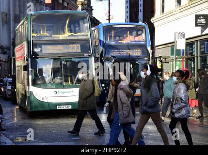 People walk past Stagecoach buses in central Manchester Stock Photo - Alamy