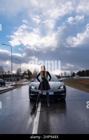 Porsche Taycan Gran Turismo Electric model driving down the road Stock ...