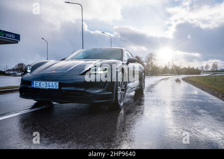Porsche Taycan Gran Turismo Electric model driving down the road Stock ...