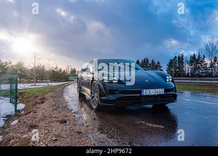 Porsche Taycan Gran Turismo Electric model driving down the road Stock ...