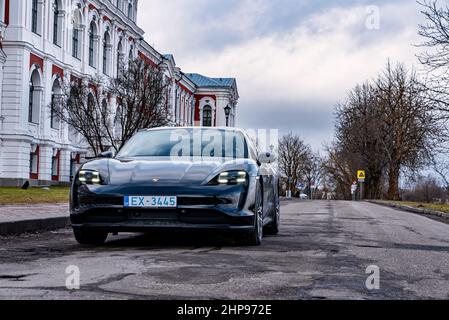 Porsche Taycan Gran Turismo Electric model driving down the road Stock ...
