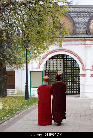 Female guides, wearing ornate traditional Russian garments, walking in ...