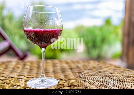 Red beet juice in a wine glass with whole beets on a wooden table Stock ...