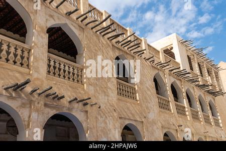 Middle eastern architecture with bamboo wooden poles sticking out of a ...