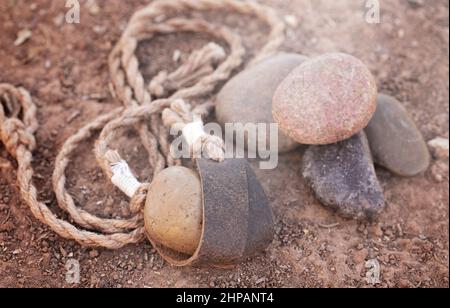Sling of David with Five Smooth Stones and Goliaths Sword in the Dirt ...