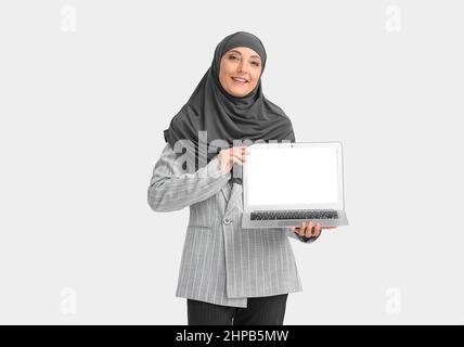 Muslim secretary with laptop on light background Stock Photo - Alamy
