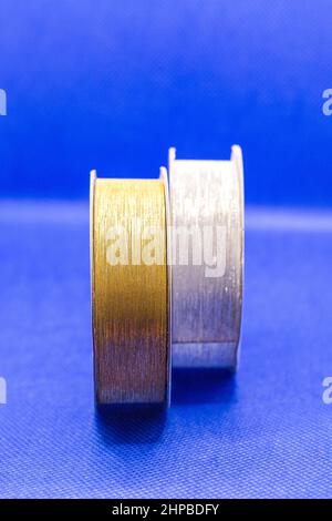 Two packing tapes in gold and silver blue background Stock Photo - Alamy